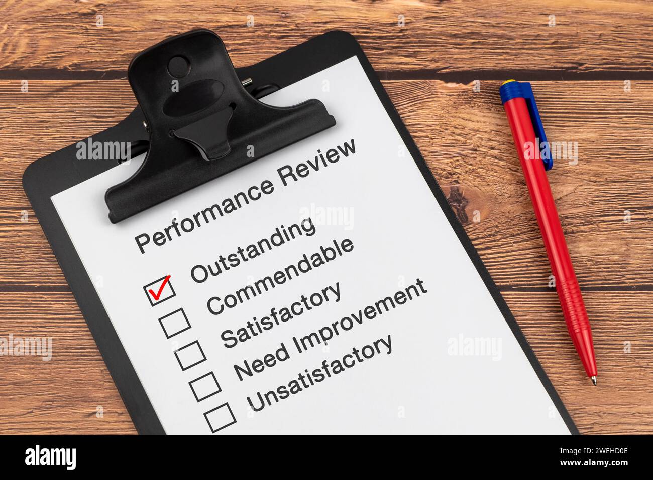 Performance review check list with pen Stock Photo - Alamy