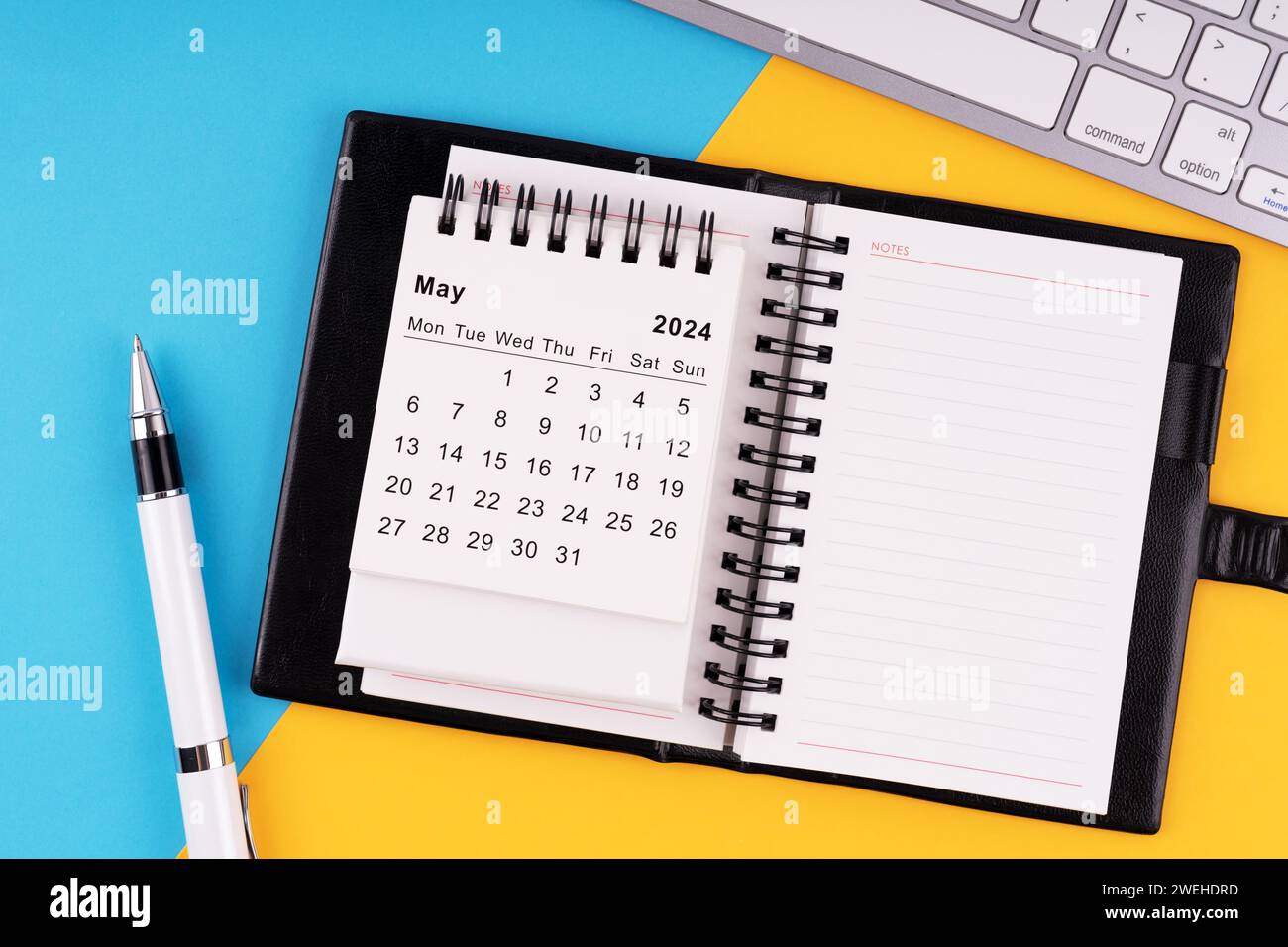 May 2024 calendar, notepad, pen and computer keyboard Stock Photo - Alamy