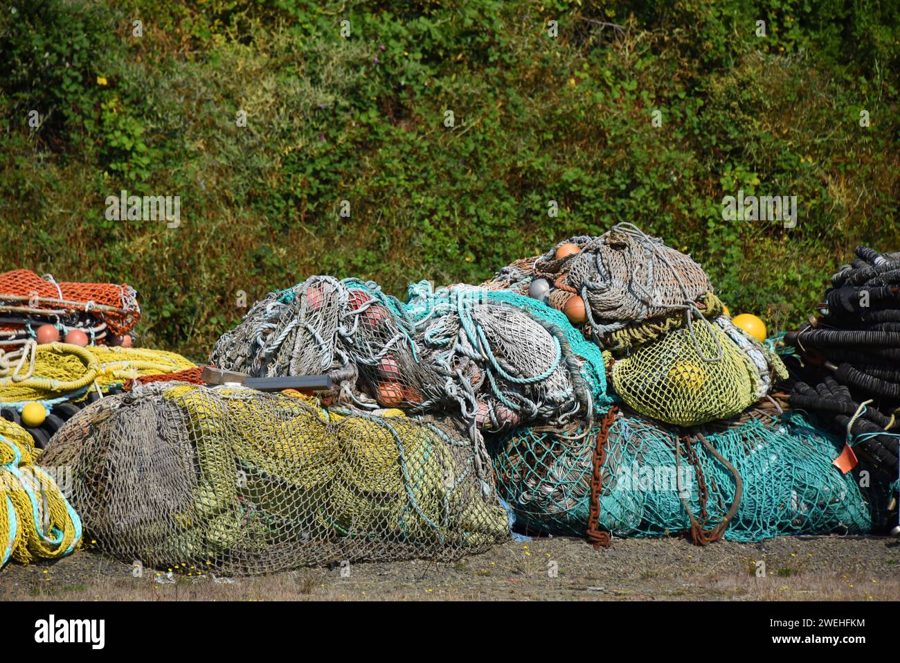 Stack of commercial fishing nets lay bundled on the ground in Newport ...