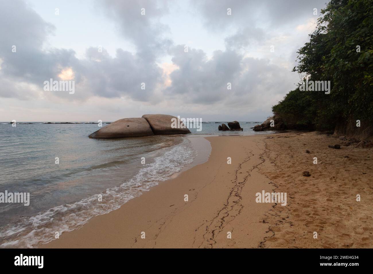 Two big rocks in la piscina beach located into tayrona park with orange ...