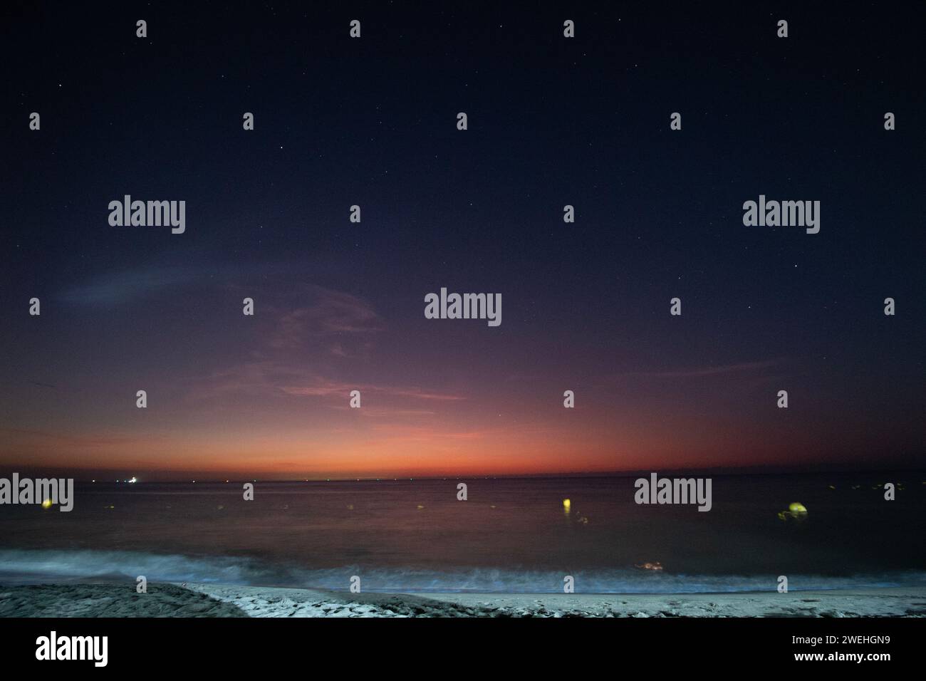 Beautiful blue and orange twilight on caribbean beach with faint stars ...