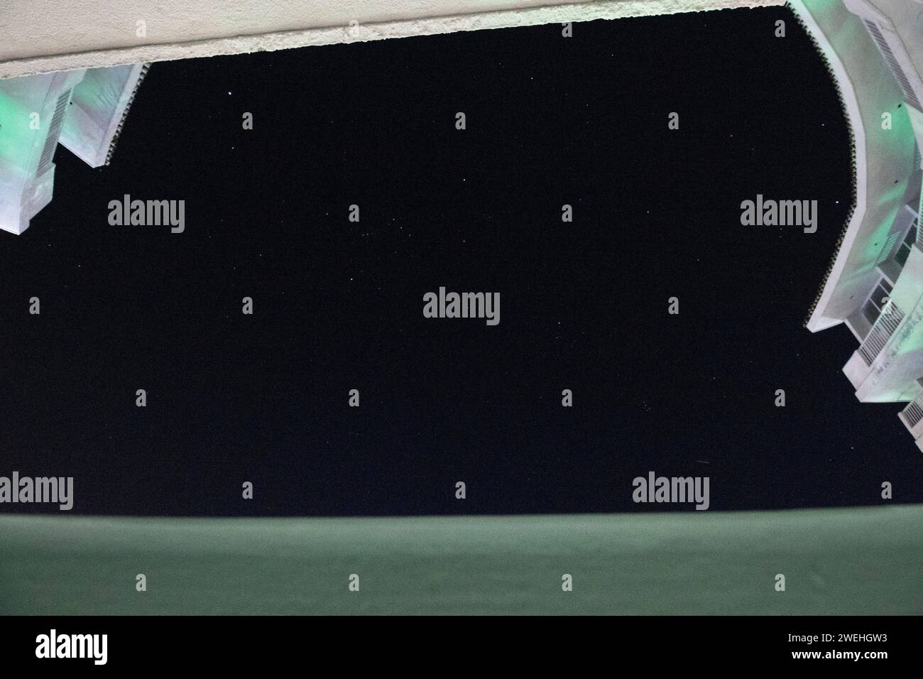 Beautiful starry night landscape viewed through a withe building ...