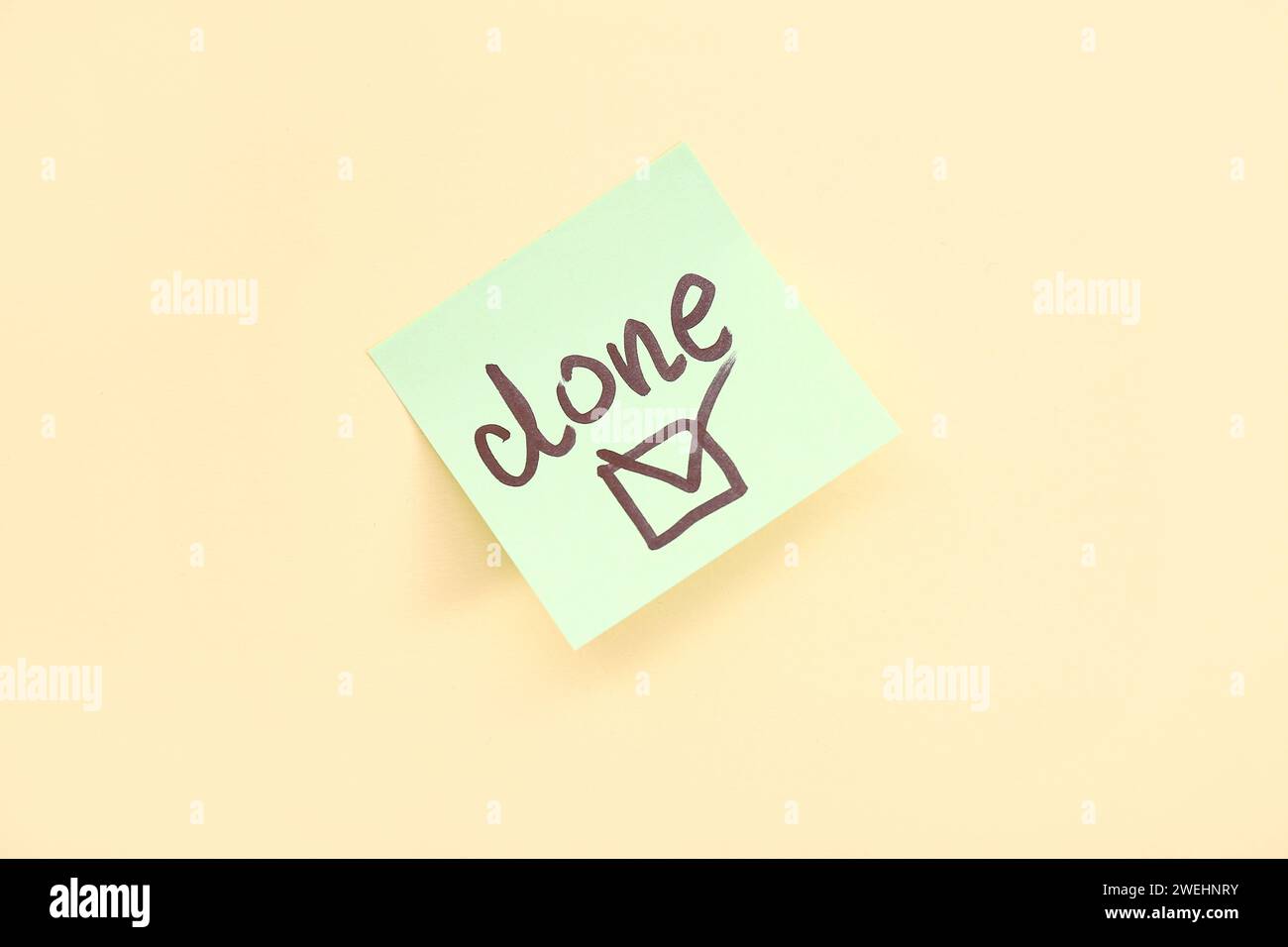 Sticky note with word DONE and check mark on beige background Stock ...