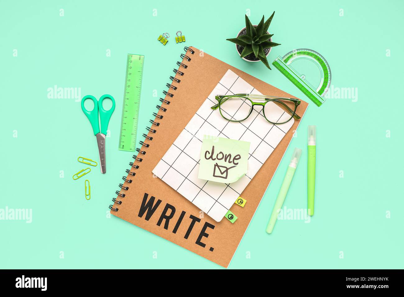Sticky note with word DONE, eyeglasses and stationery on green ...