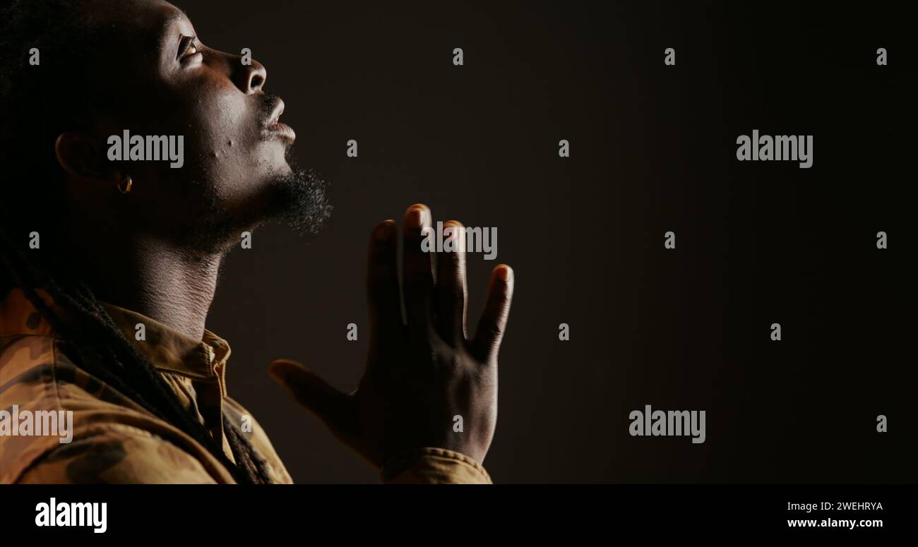 Religious adult believing in Jesus and praying in studio, showing ... Religious adult believing in Jesus and praying in studio, showing ...