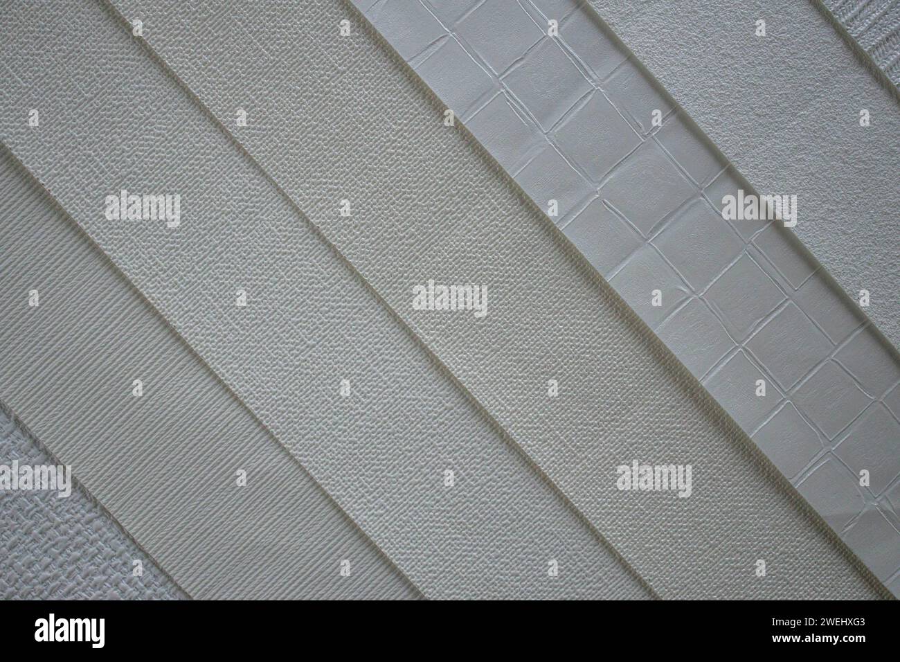 A collection of interior wallpaper samples in textured beige shades ...
