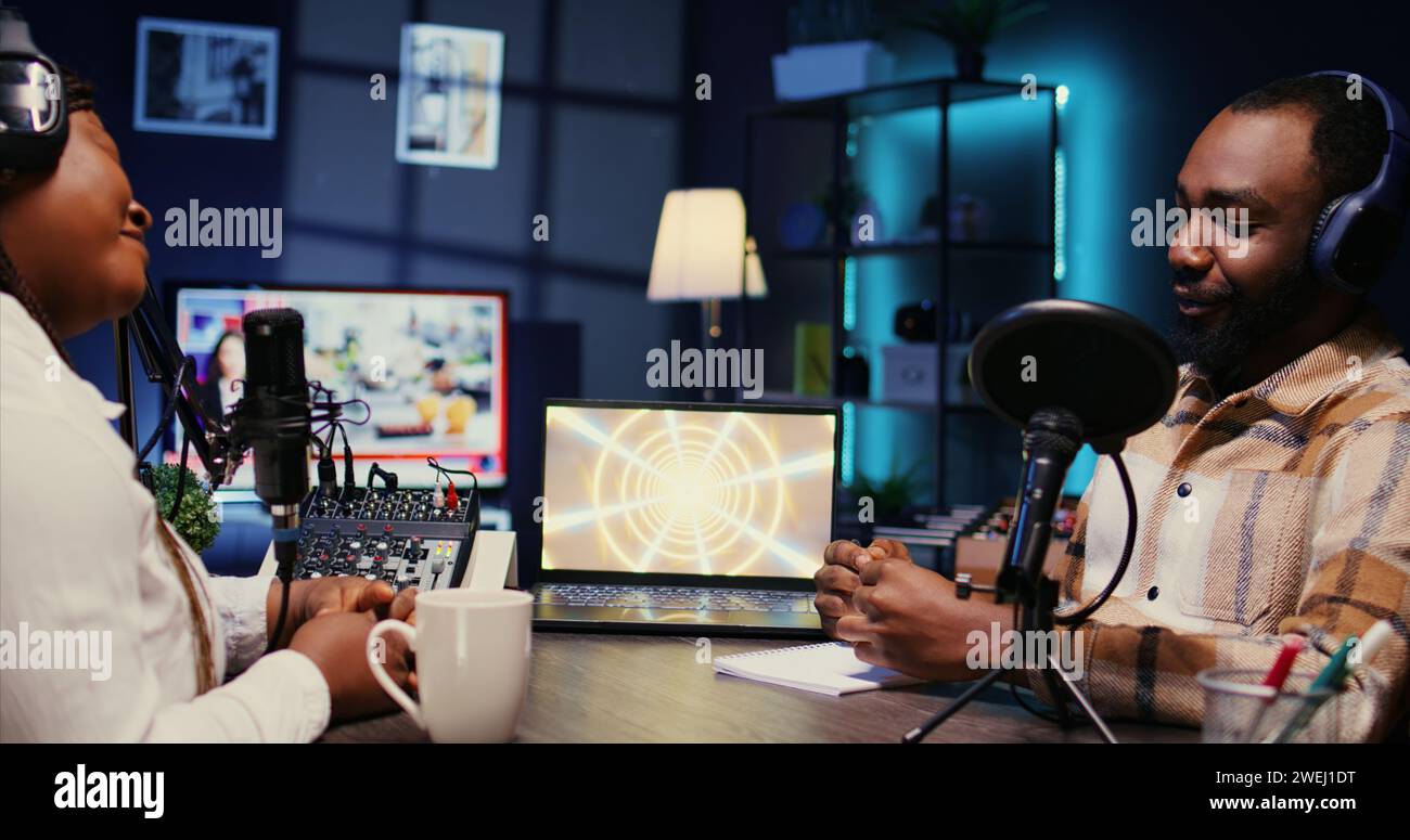 Woman radio show presenter having live conversation with man, recording ...