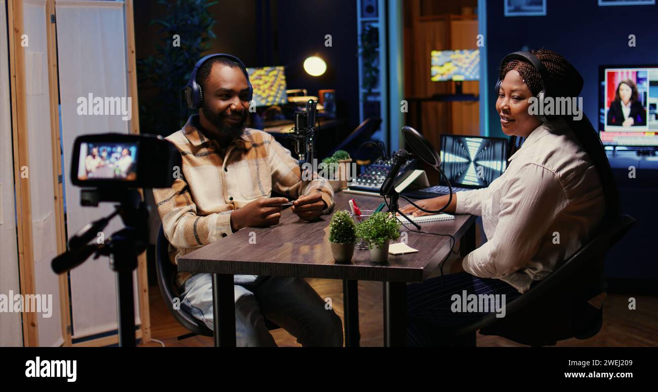 Man and woman laughing during comedy focused podcast filmed with ...