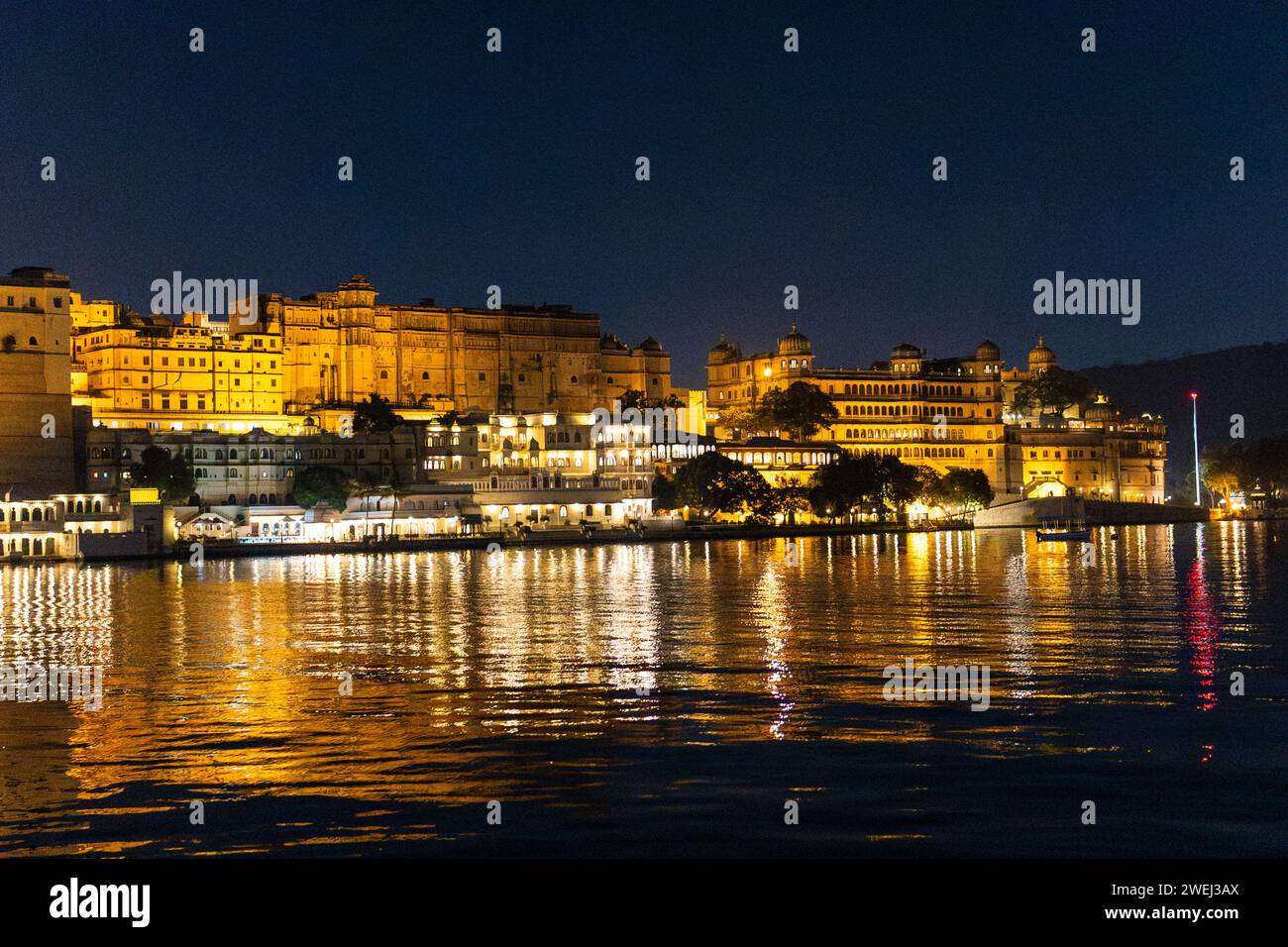 new modern architecture buildings at the banks of lake at night image ...