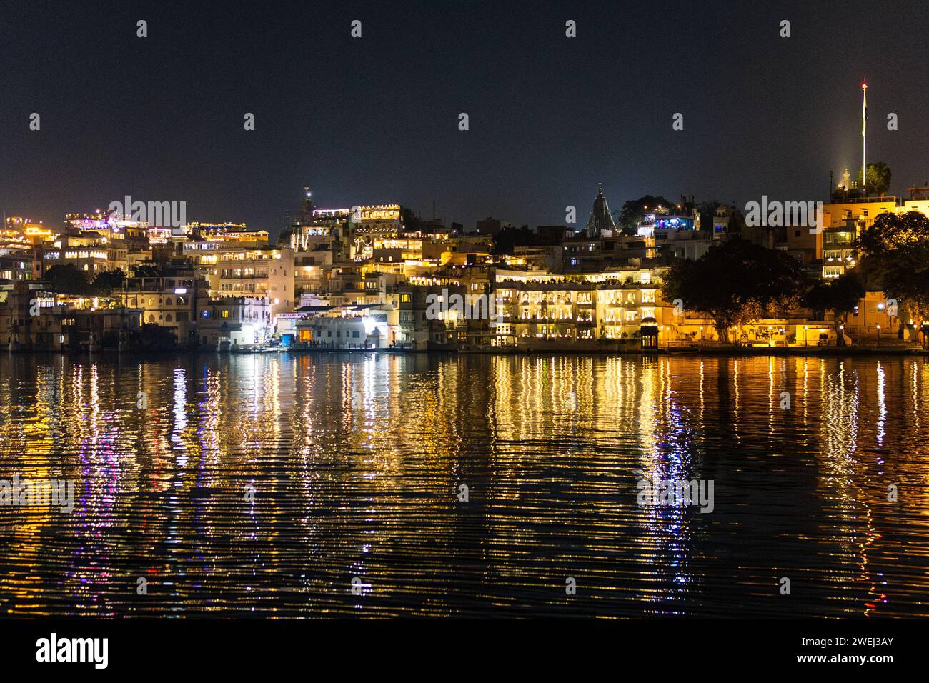 new modern architecture buildings at the banks of lake at night image ...