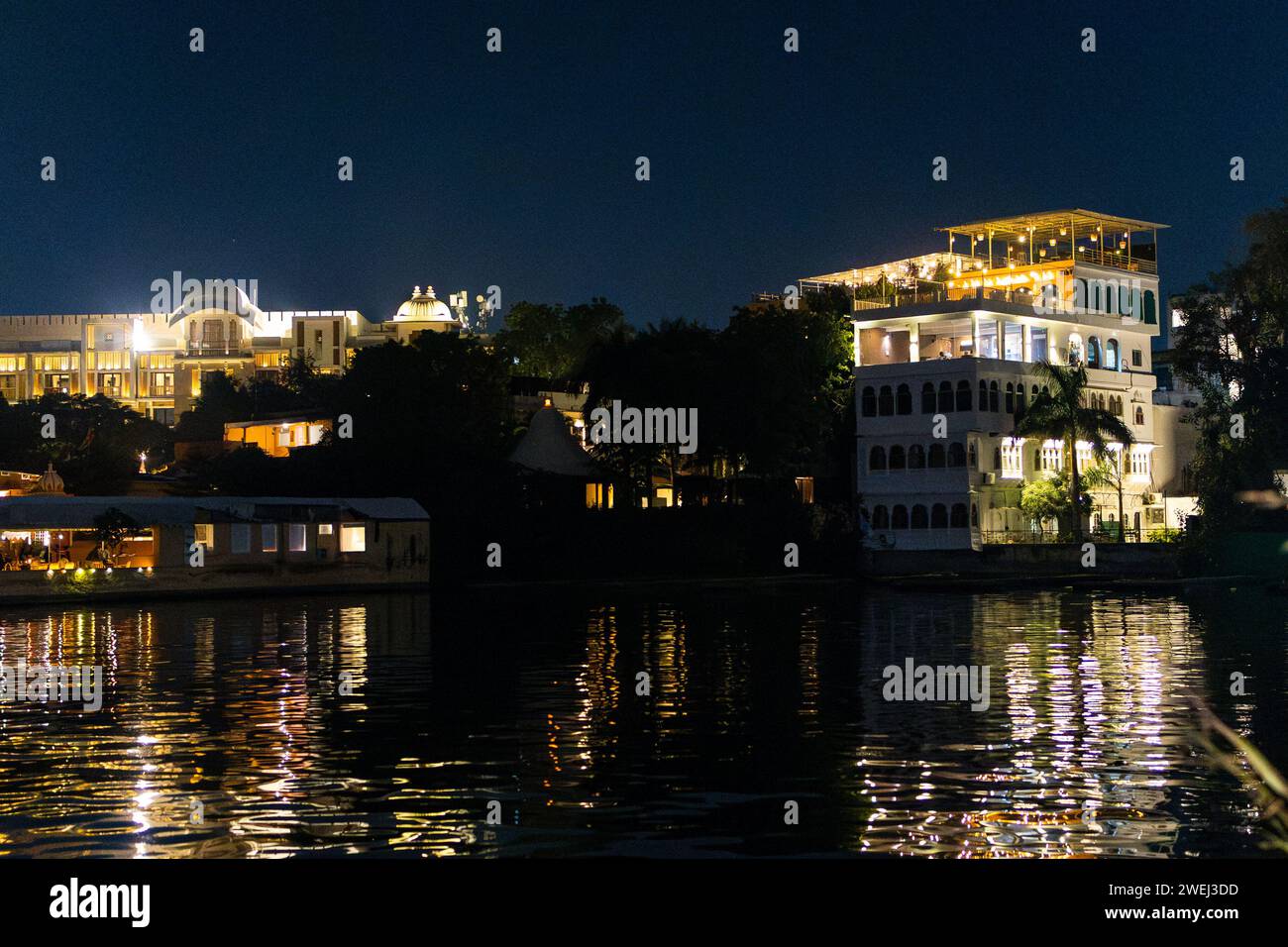 new modern architecture buildings at the banks of lake at night image ...