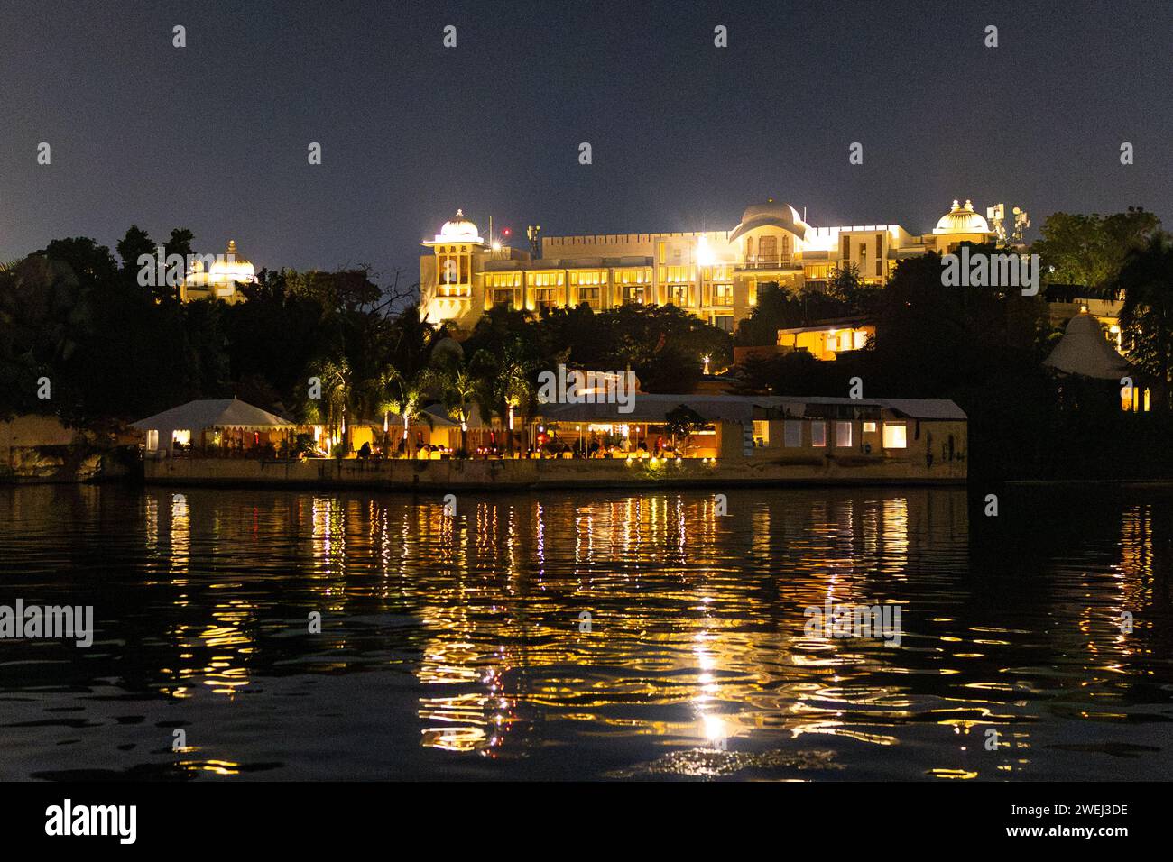 new modern architecture buildings at the banks of lake at night image ...