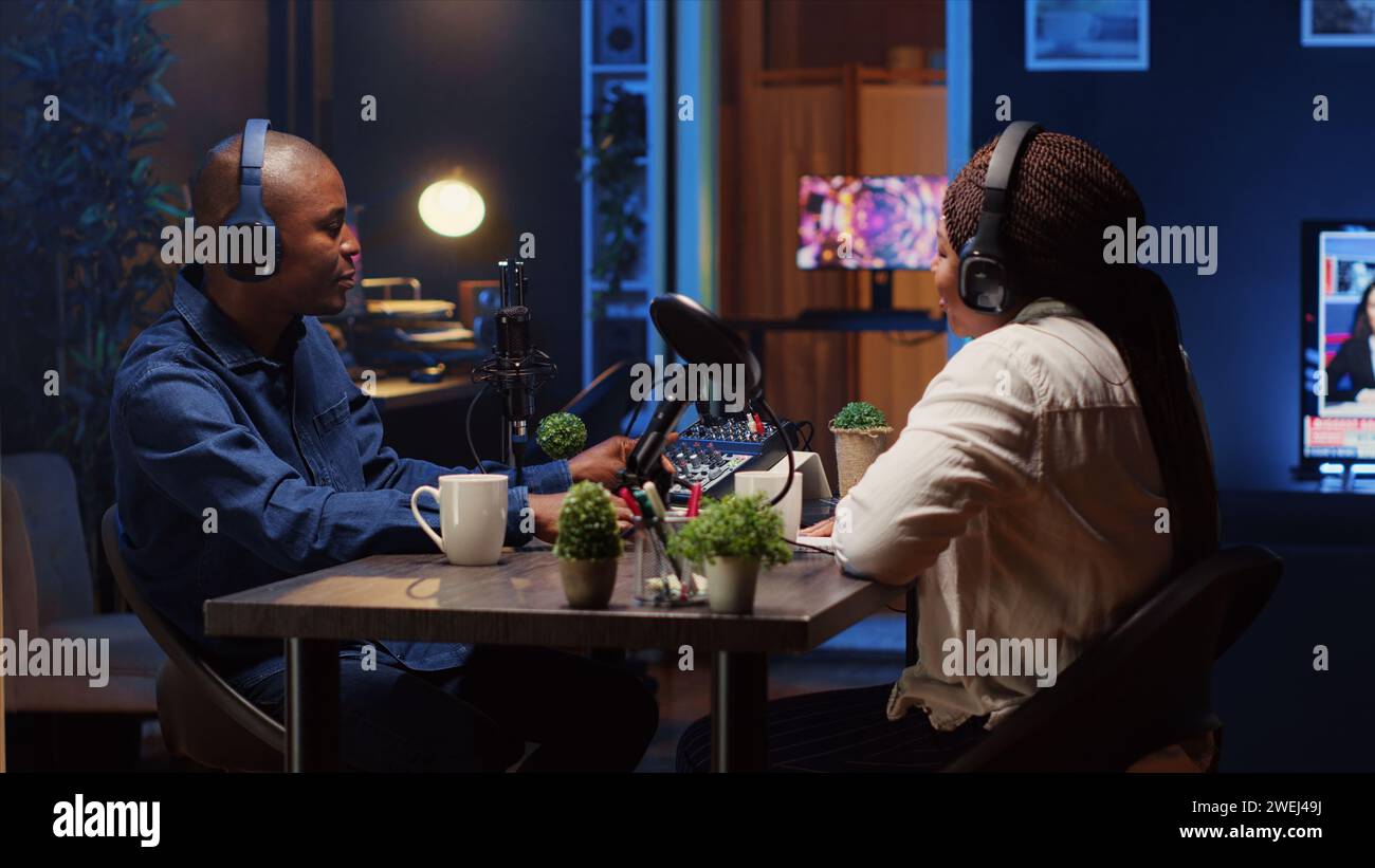 Online show host recording podcast with guest, using analog mixer ...