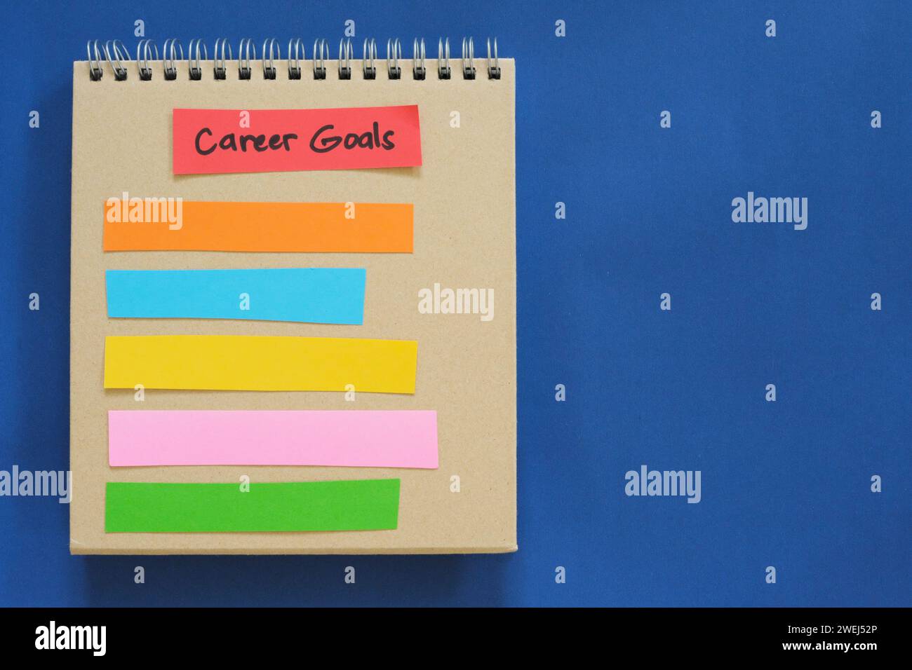 Career goals concept. Checklist of goals in note pad in blue background ...