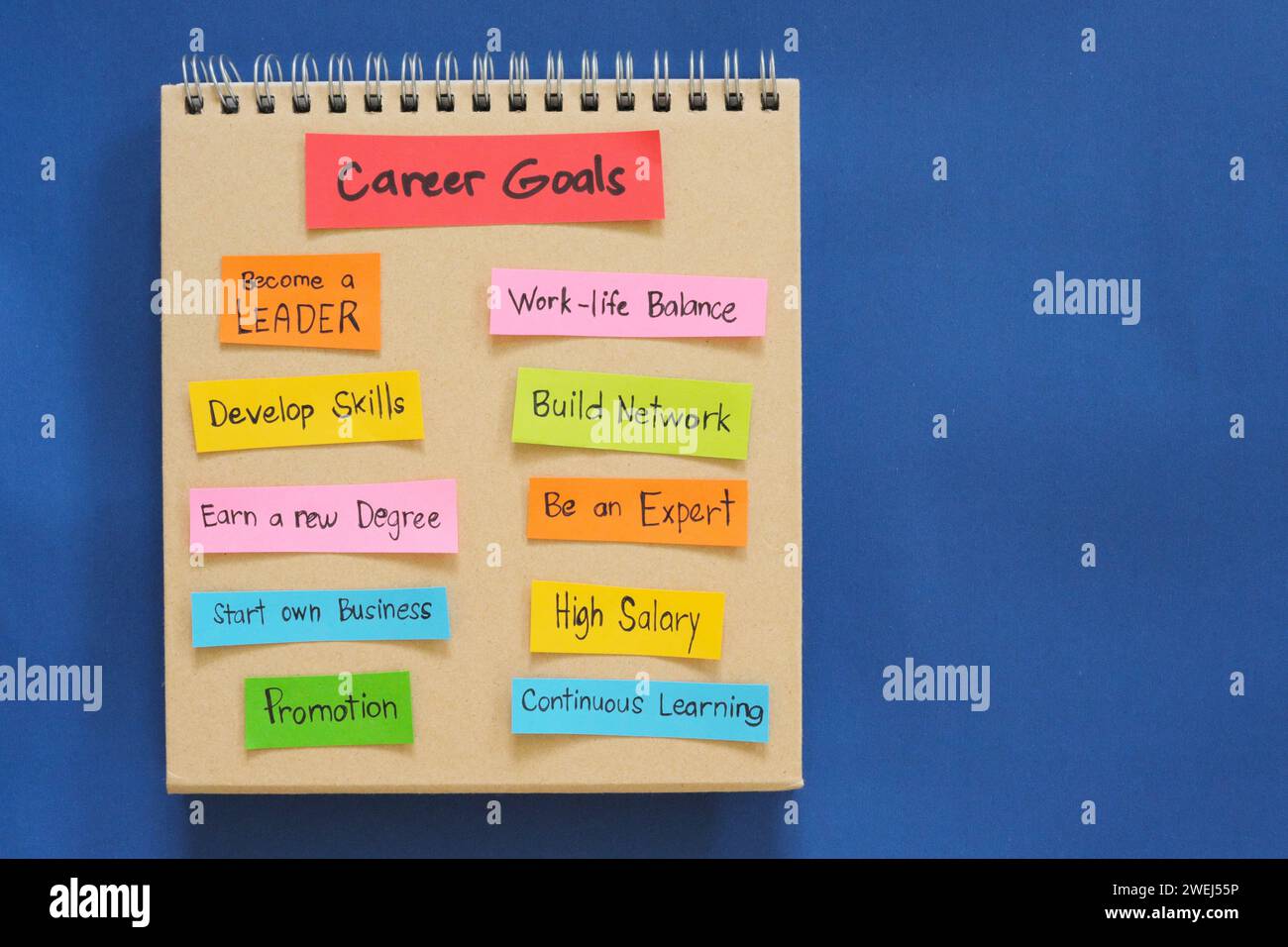 Career goals concept. Checklist of goals in note pad in blue background ...
