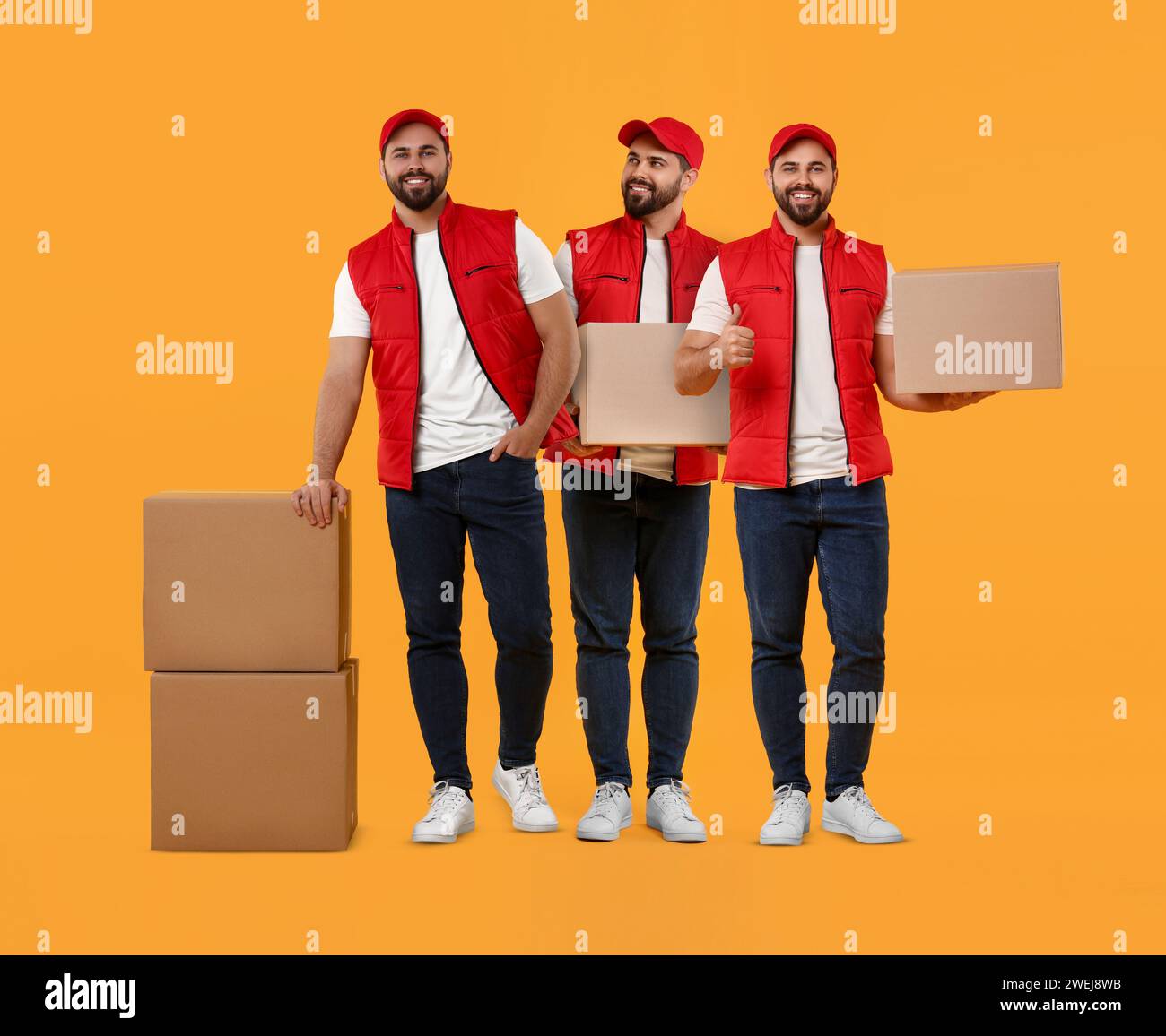 Delivery service. Happy courier with cardboard boxes on orange ...