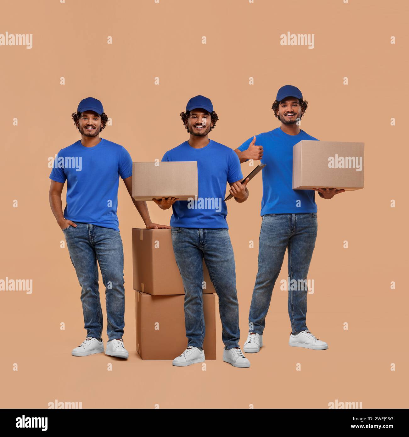 Delivery service. Happy courier with cardboard boxes on peach color ...