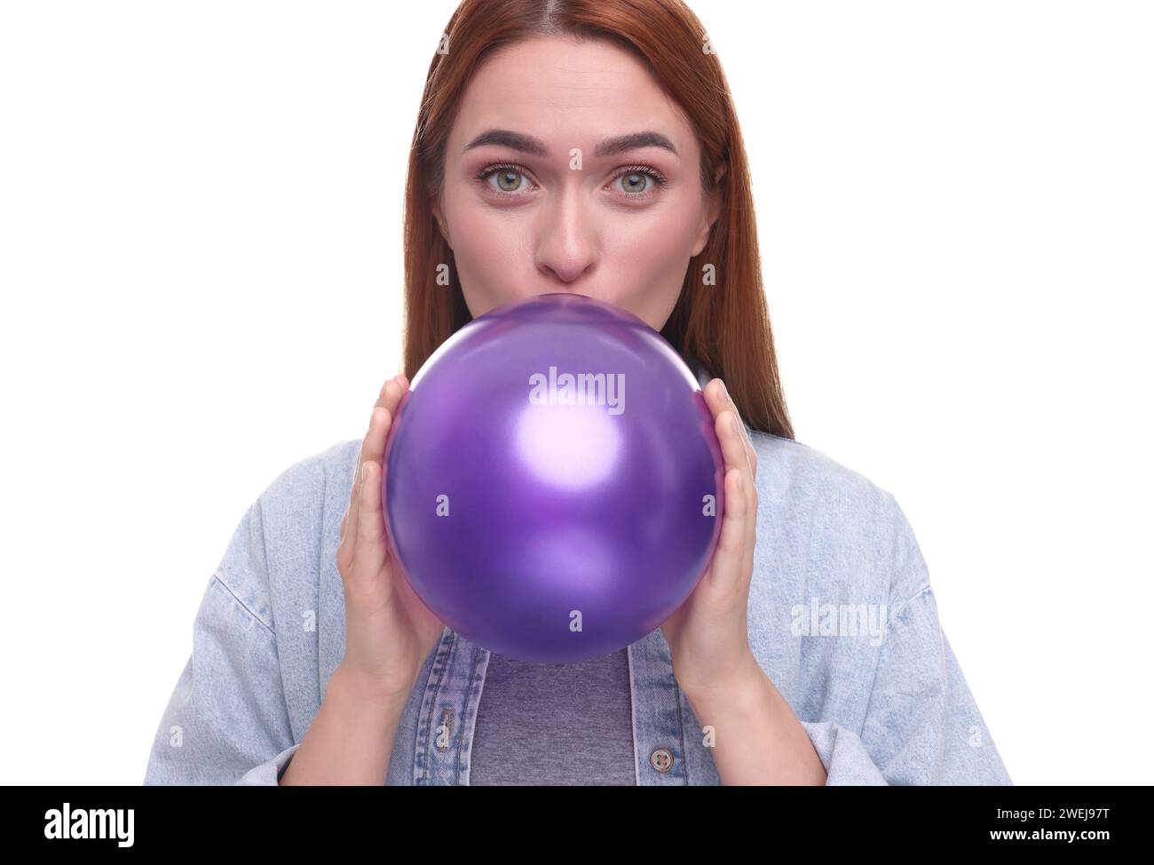 Woman inflating purple balloon on white background Stock Photo - Alamy