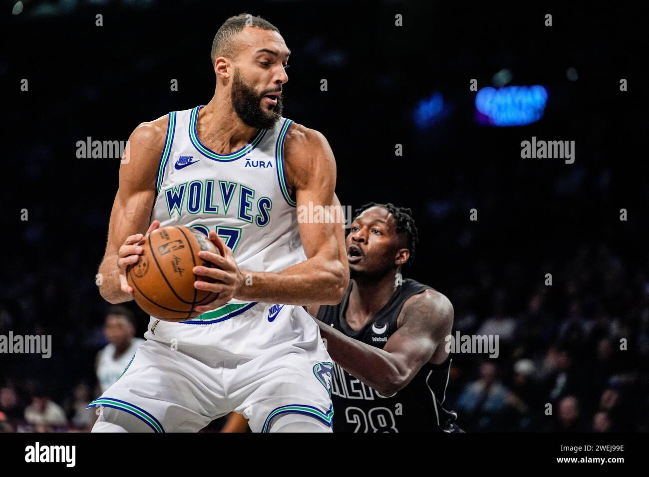 Minnesota Timberwolves center Rudy Gobert, left, is defended by Brooklyn Nets forward Dorian ...