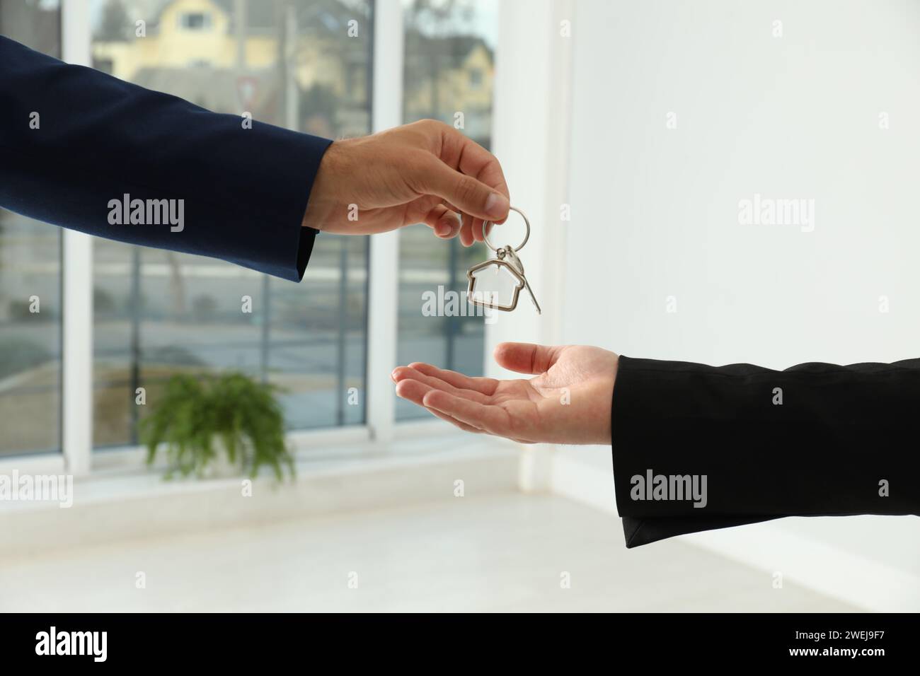 Real estate agent giving key to client in new house, closeup Stock ...