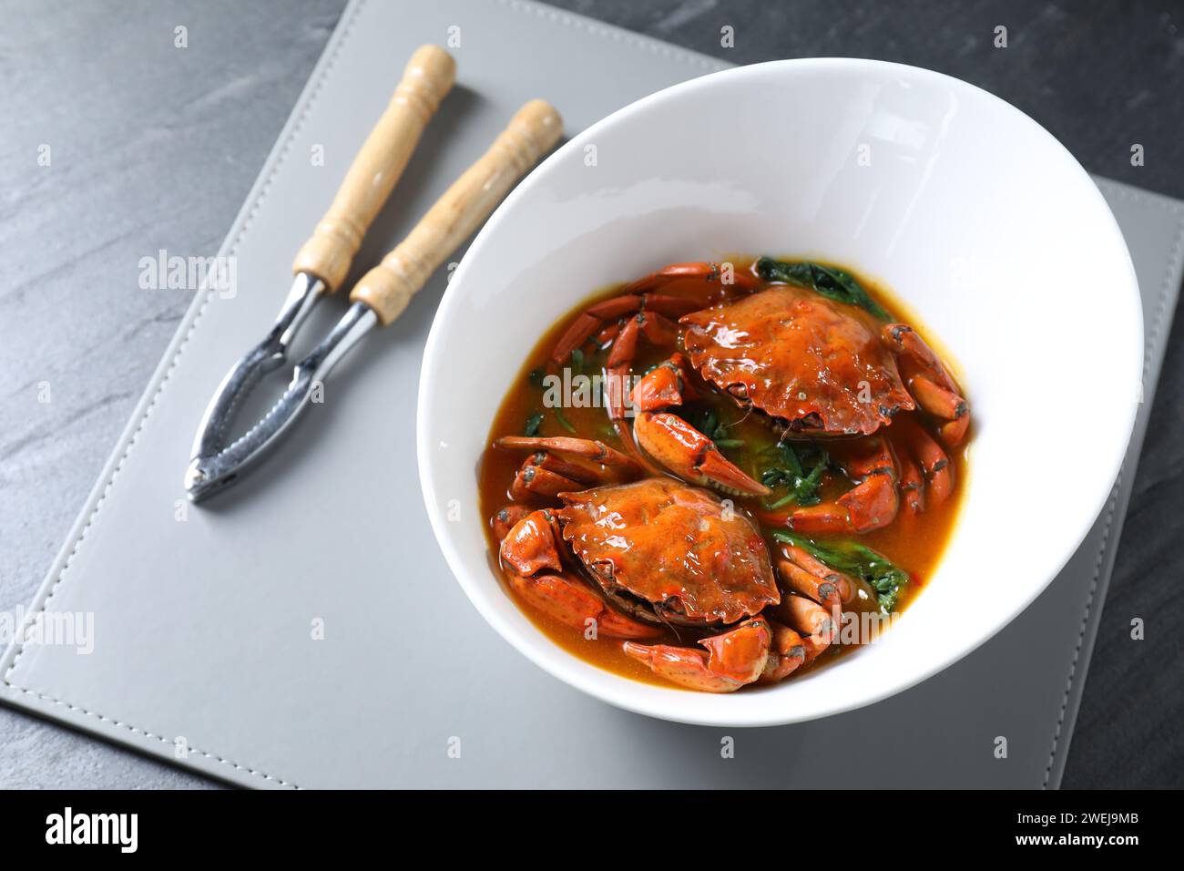 Delicious boiled crabs with sauce and cracker on grey table, above view Stock Photo - Alamy