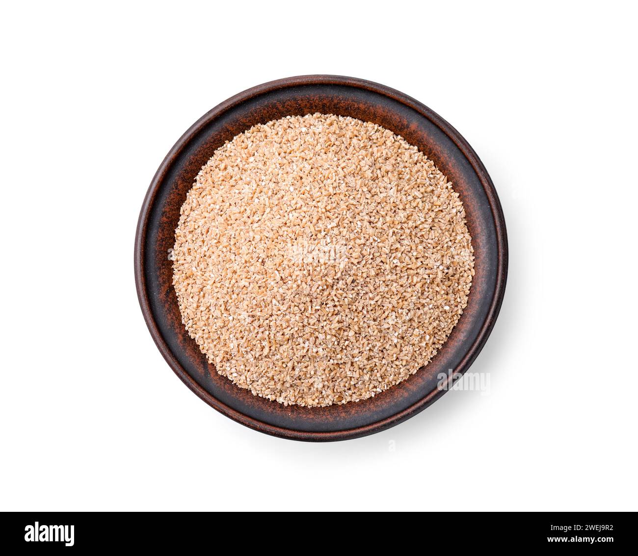 Dry wheat groats in bowl isolated on white, top view Stock Photo - Alamy