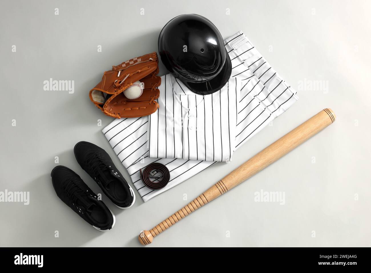 Baseball uniform and other sports equipment on white background, flat ...