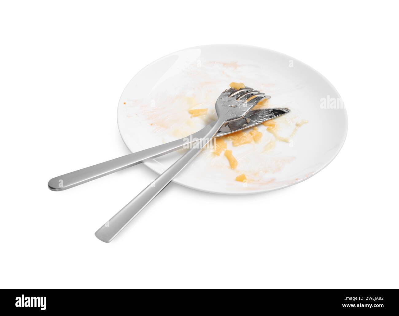 Dirty plate and cutlery on white background Stock Photo - Alamy