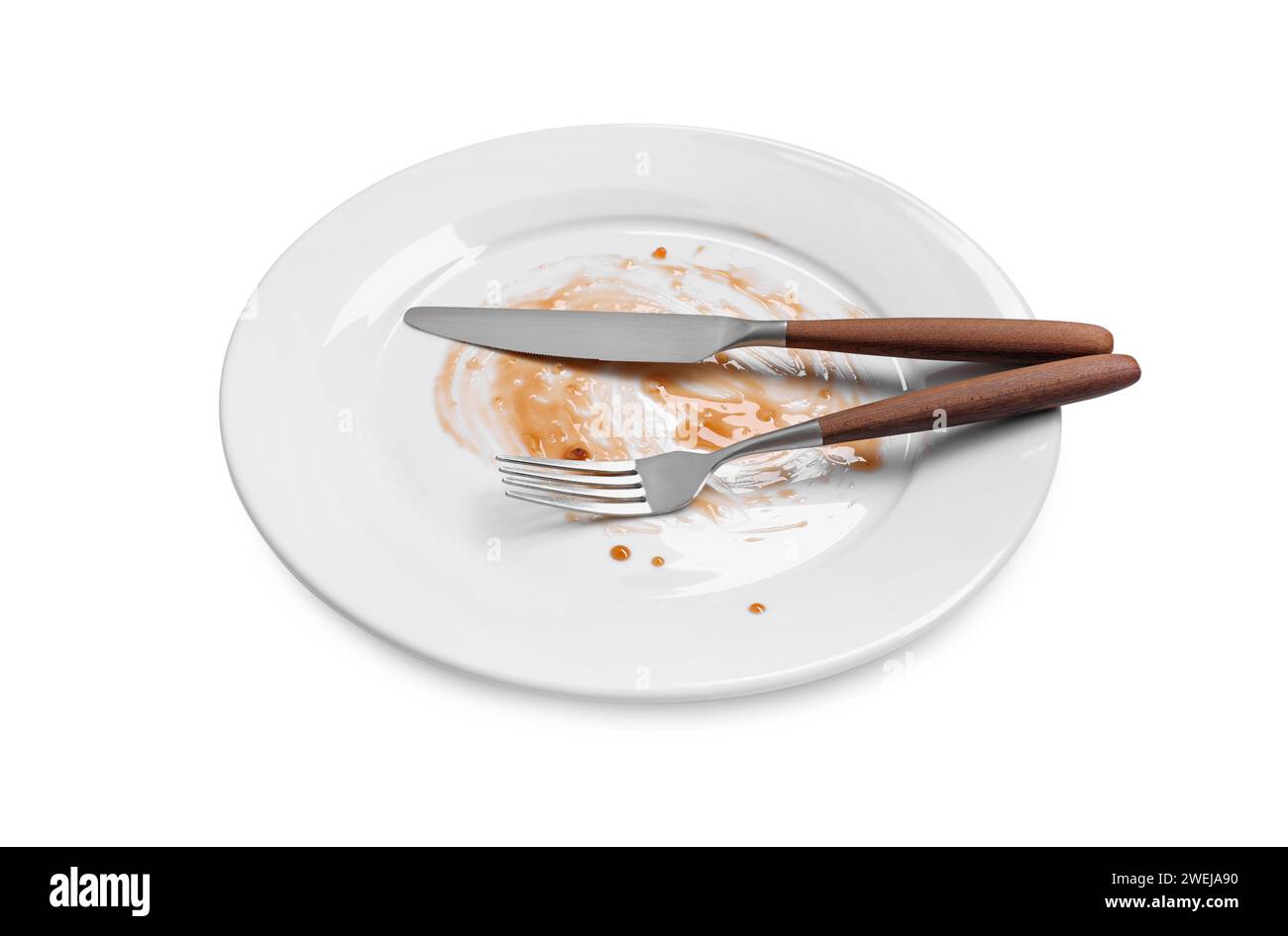 Dirty plate and cutlery on white background Stock Photo - Alamy