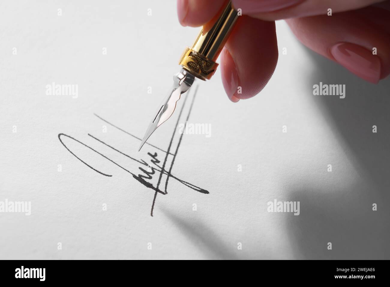Woman signing on sheet of paper with fountain pen, closeup Stock Photo ...