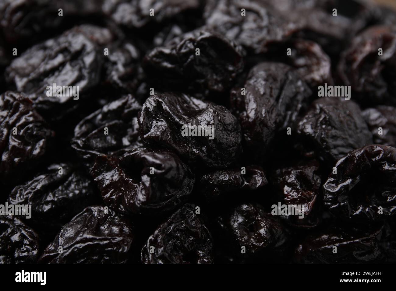 Sweet dried prunes as background, closeup view Stock Photo - Alamy