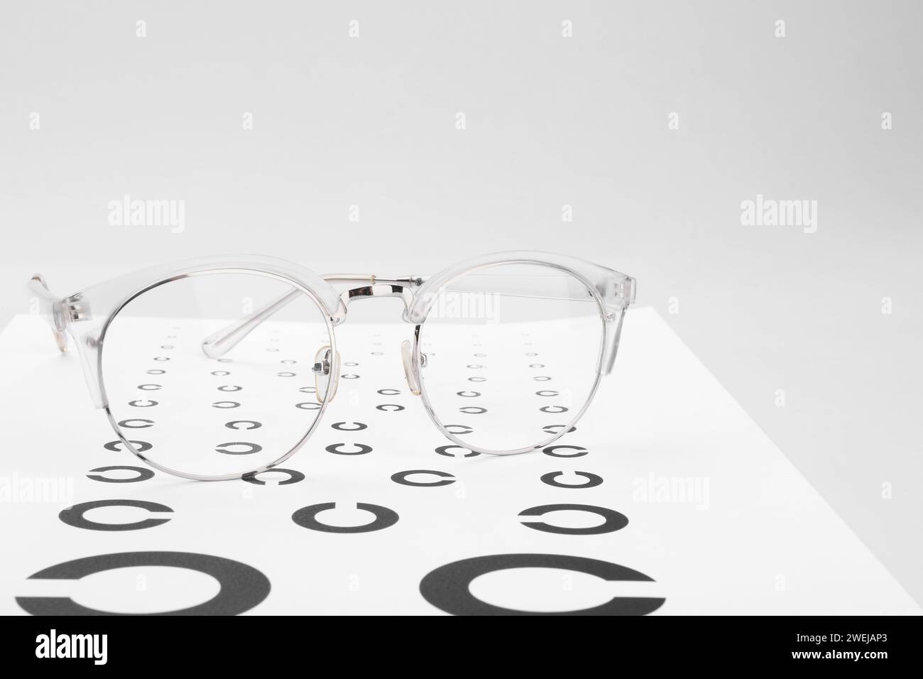 Glasses and vision test chart isolated on white Stock Photo - Alamy
