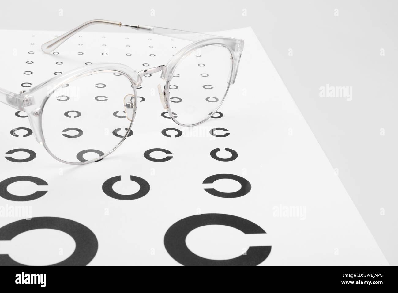 Glasses and vision test chart isolated on white Stock Photo - Alamy