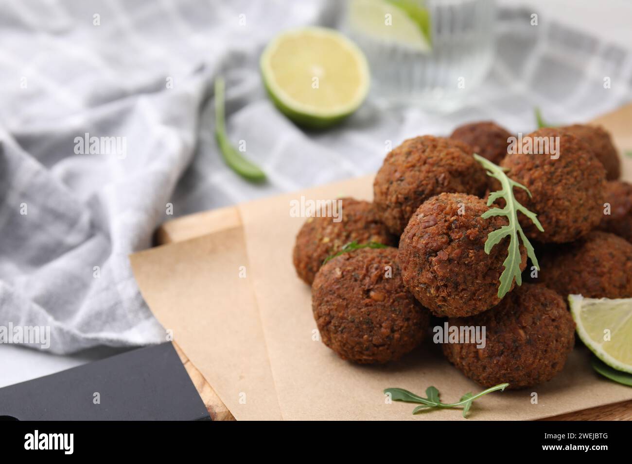 Delicious falafel balls and arugula on table, closeup. Space for text ...