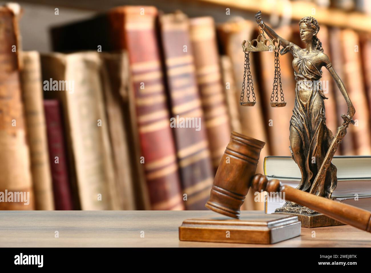 Law. Statue of Lady Justice, gavel and books on wooden table indoors ...