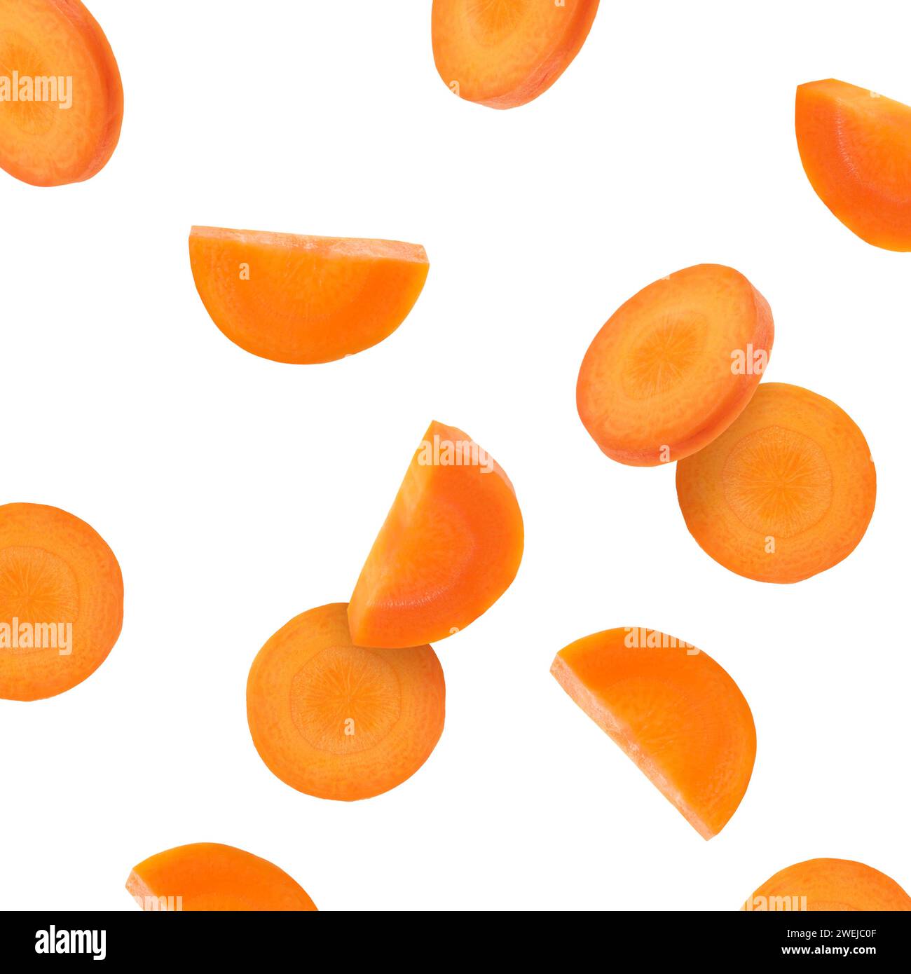 Fresh carrot slices falling on white background Stock Photo - Alamy
