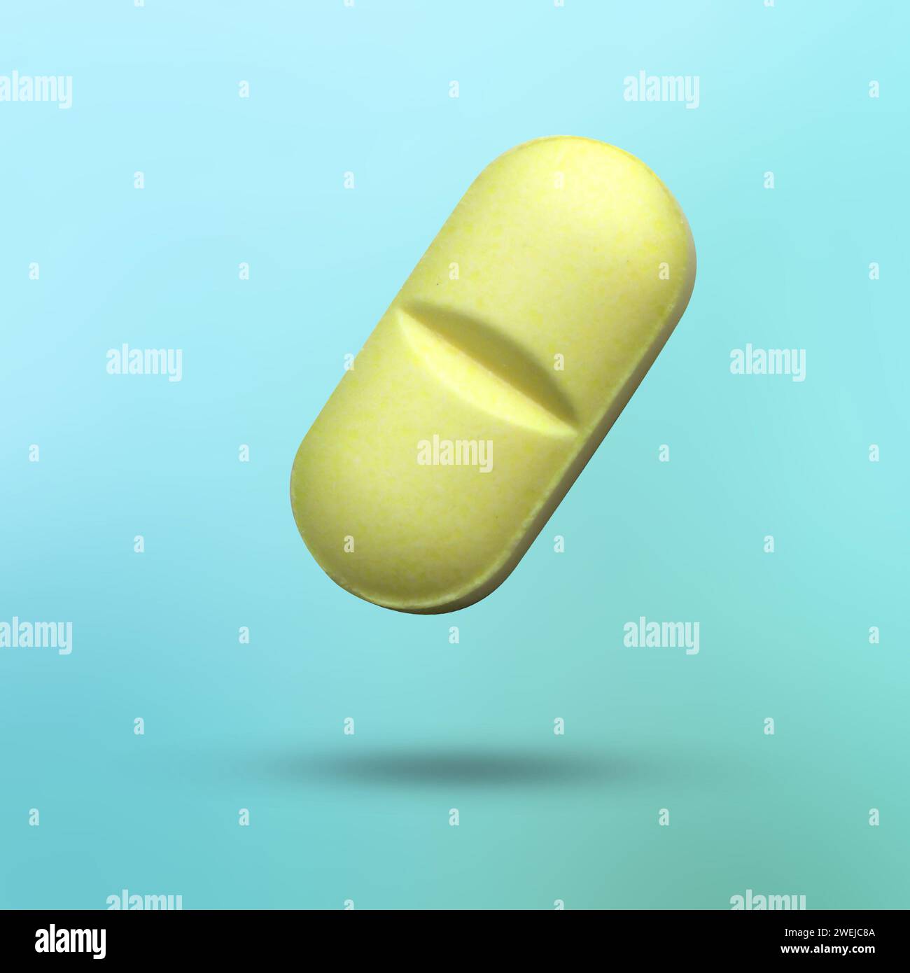 Colorful vitamin pill in air on light blue background Stock Photo - Alamy