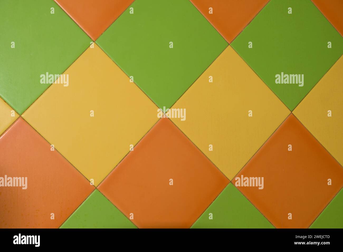 Background of rectangular tiles in a triangle of green, yellow, orange ...