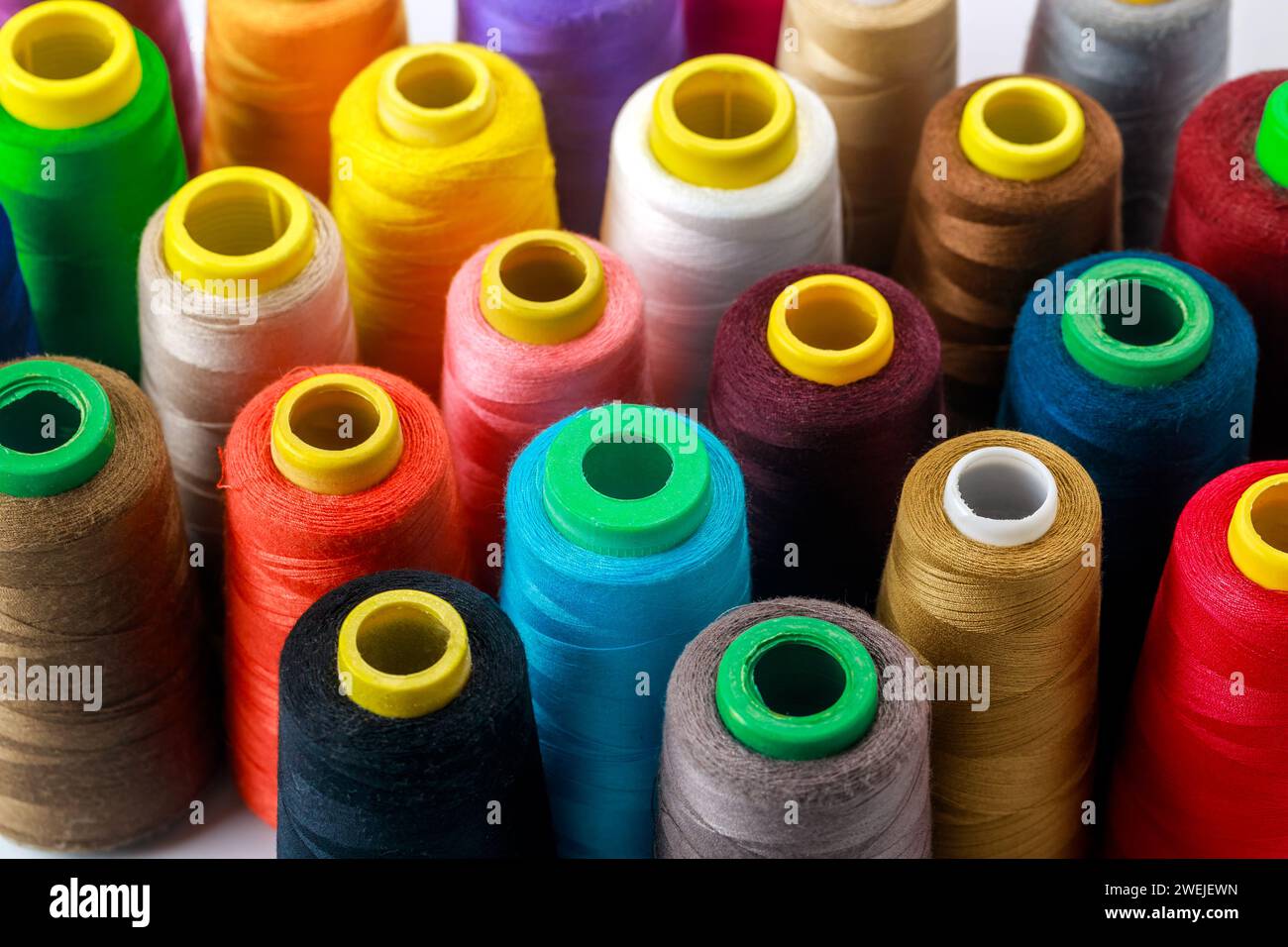 Sewing thread spool with colored threads Stock Photo - Alamy