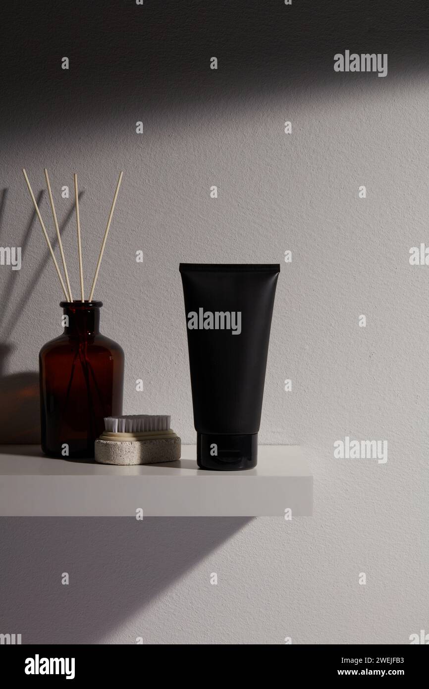 Front view of a black bottle unlabeled, beige brush and reed diffuser ...