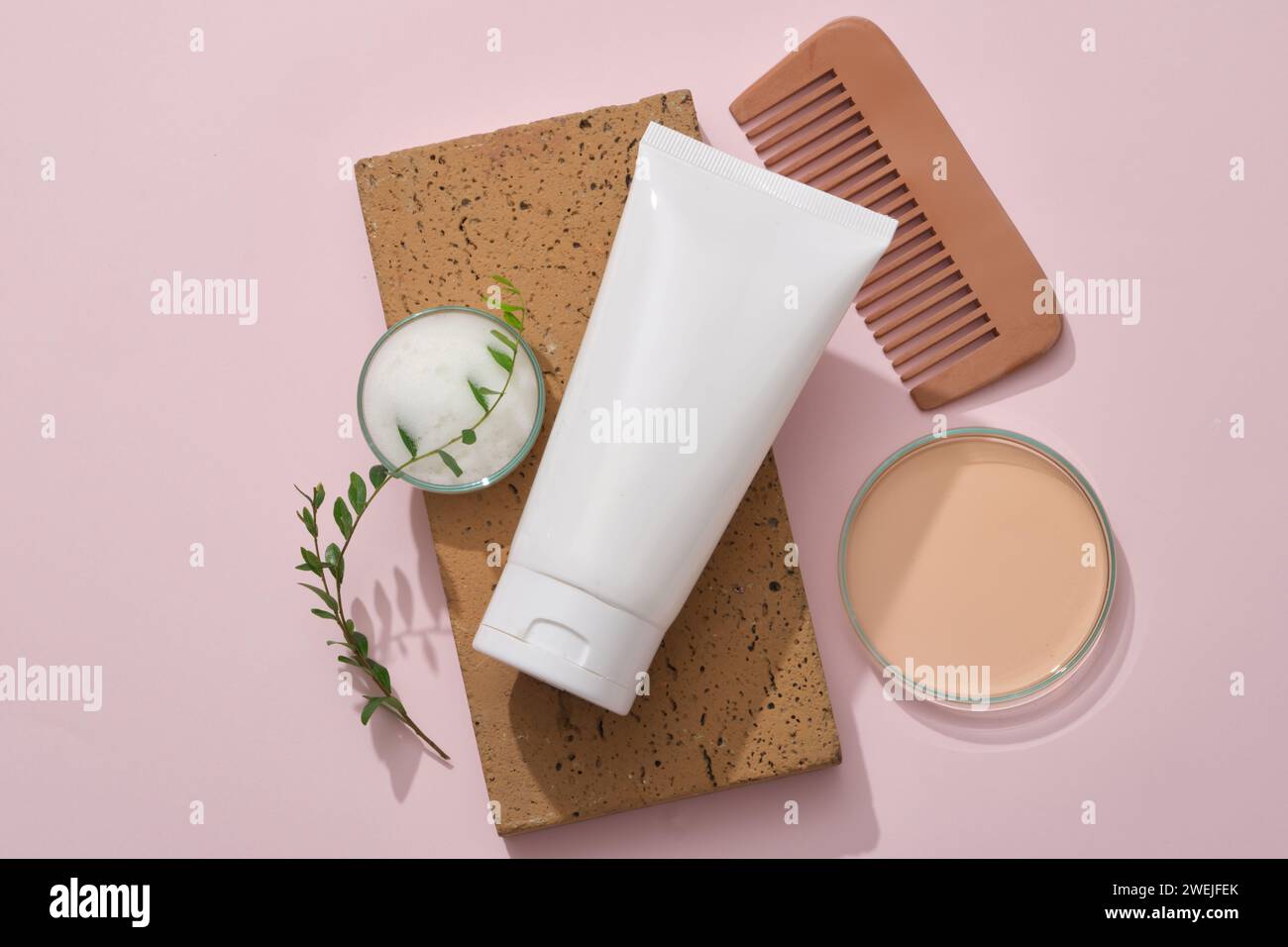 White plastic tube on brown brick, petri dish containing liquid and ...