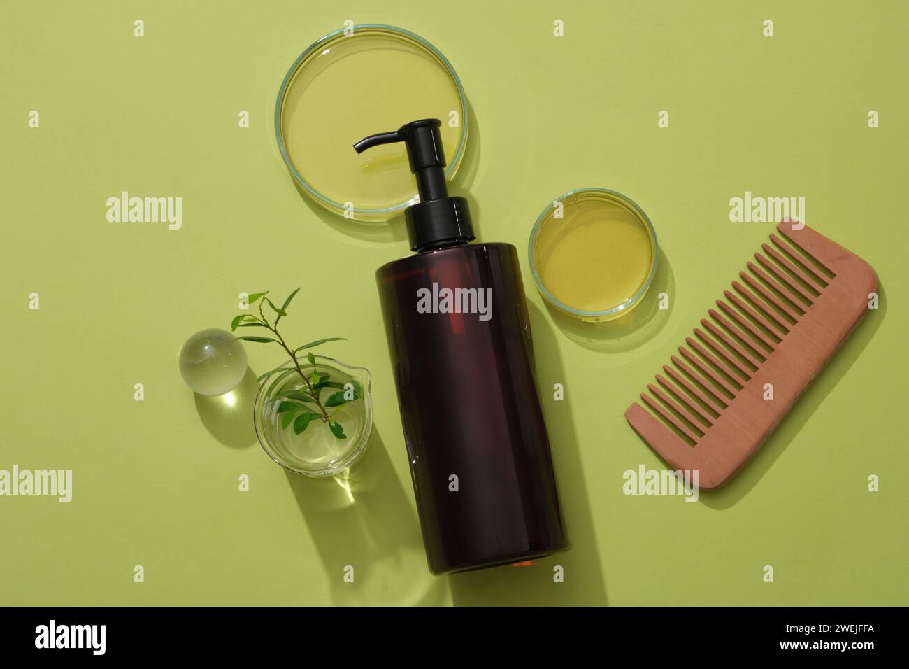 Cosmetic amber bottle unlabeled containers shampoo on green background ...