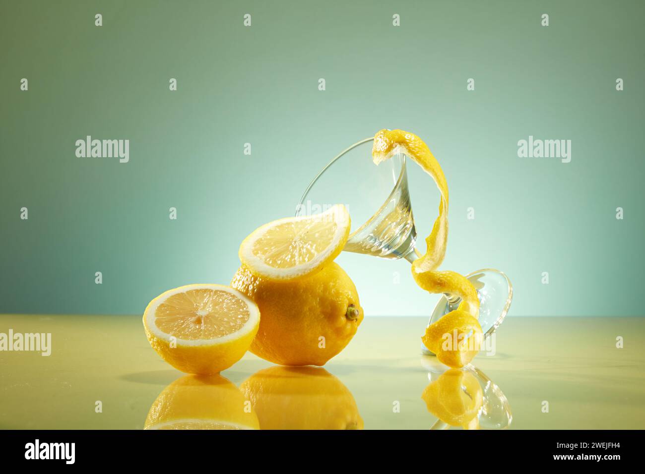 Fresh lemon and lemon slices decorated with glass cup and lemon peel on ...