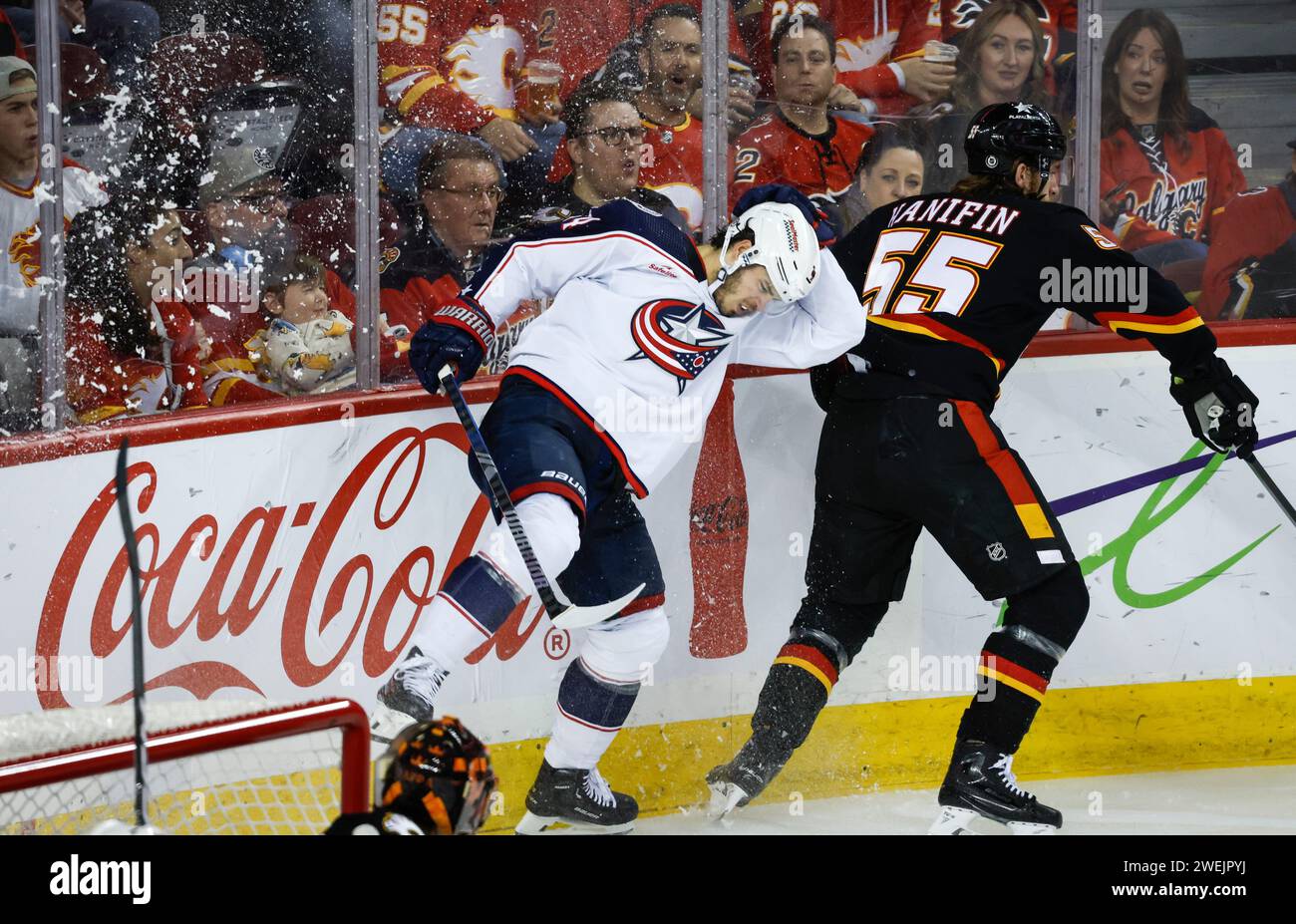 Columbus Blue Jackets forward Cole Sillinger (4) is checked by Calgary ...