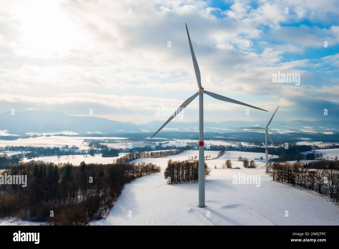 Wind turbine standing in the field in sunny winter day. Green energy ...