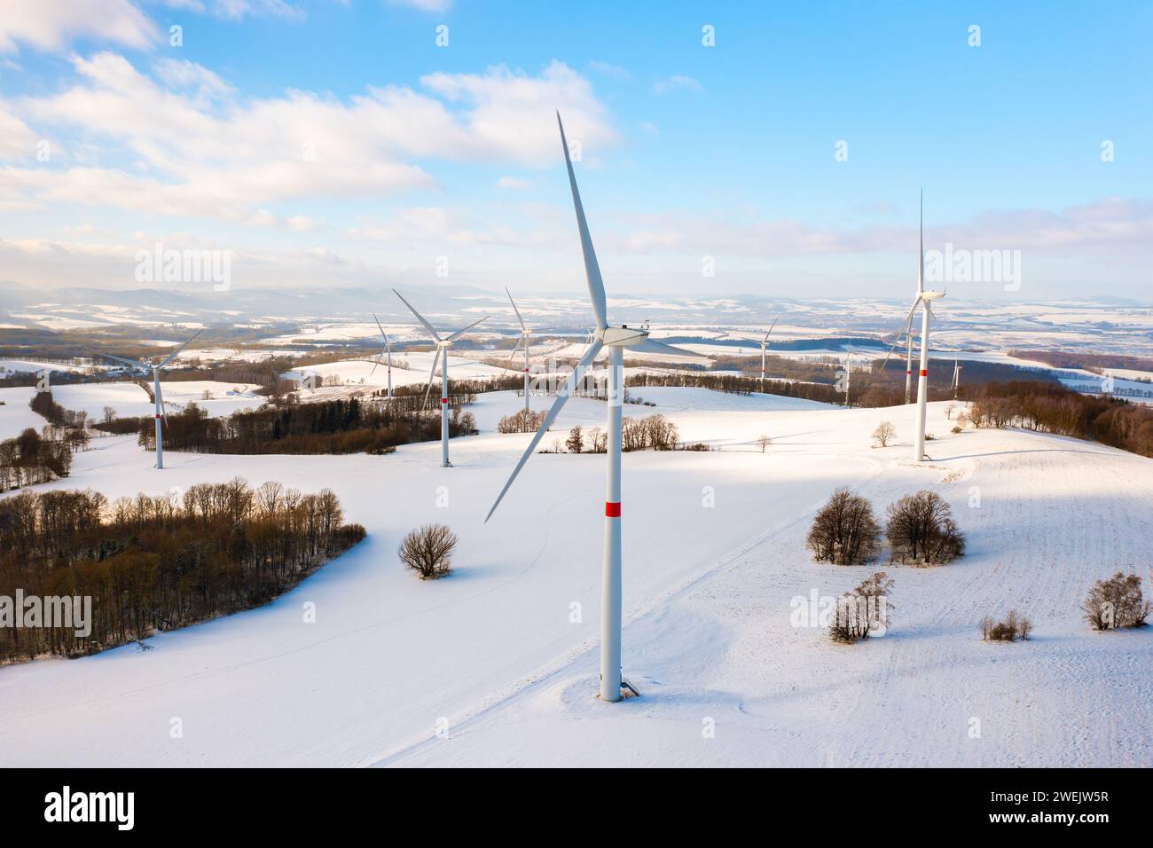 Aerial view of a wind turbine park in the winter field as a hub of ...