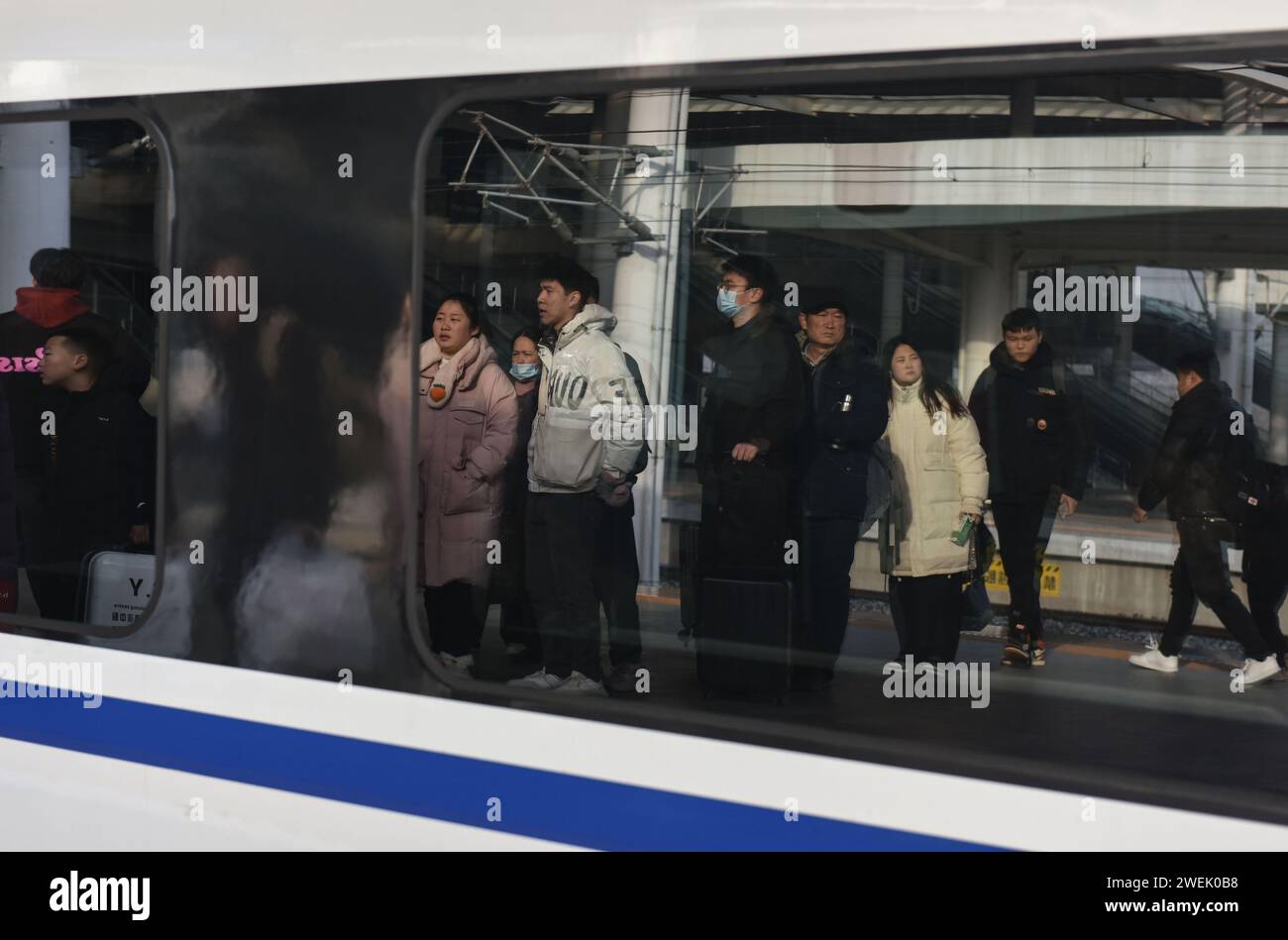 FUYANG, CHINA - JANUARY 26, 2024 - Passengers are reflected on the ...