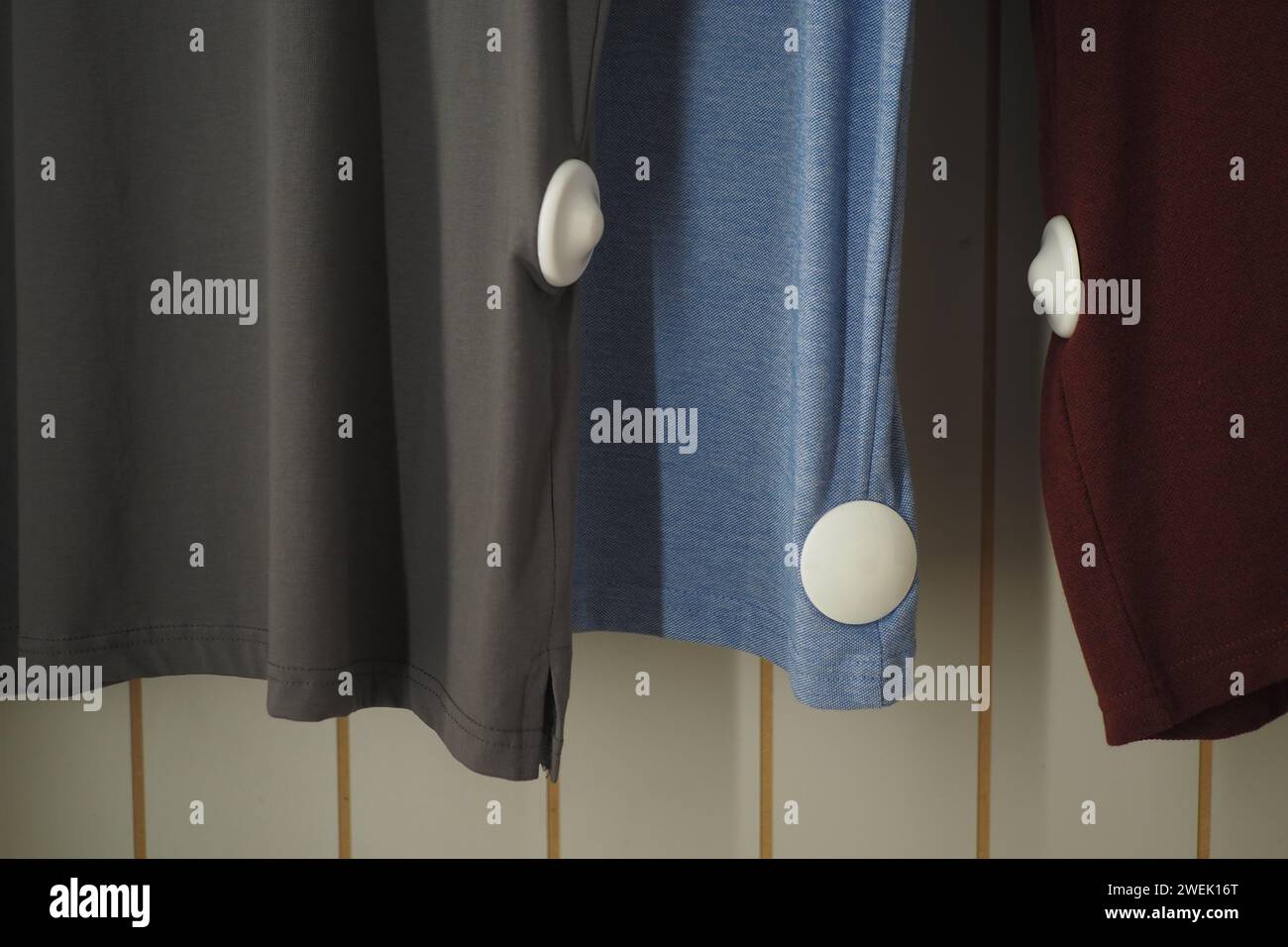 Clothing security tag on a shirt Stock Photo - Alamy