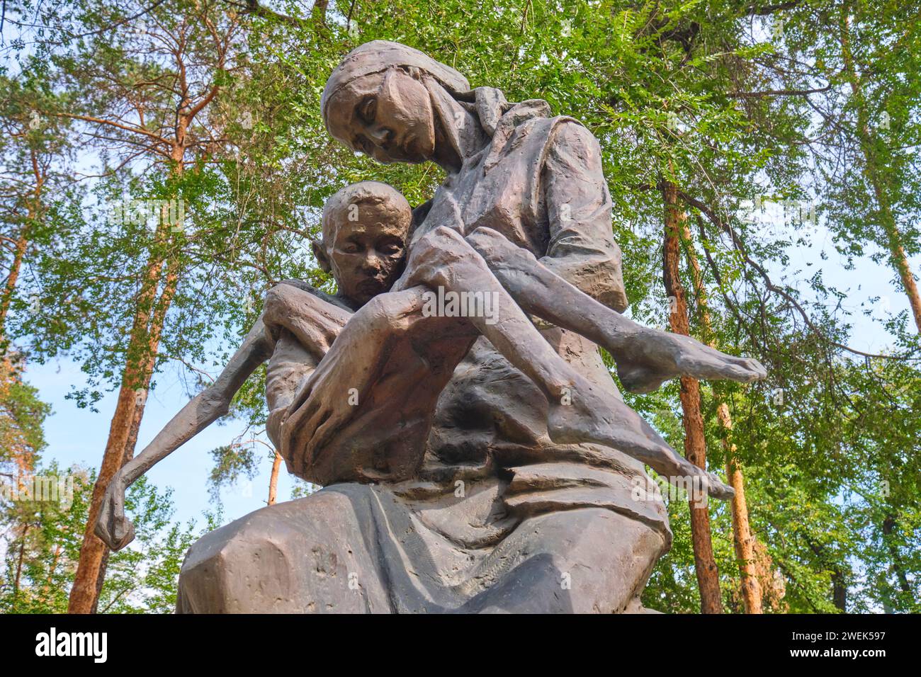 A statue of a skinny, starving child in his mother's arms. The work is ...