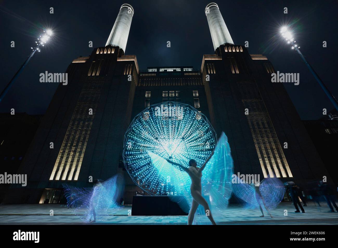 Performers dance in front of a light installation "Singularity ...